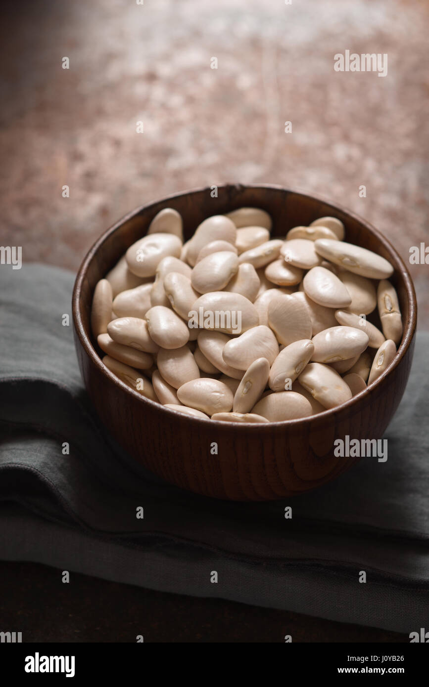 Large white beans in a wooden bowl side view vertical Stock Photo - Alamy