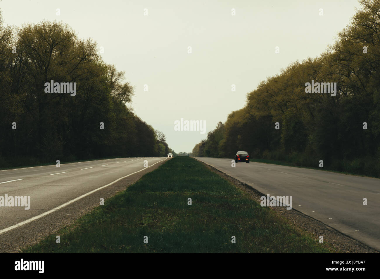 Cars drive along sunset road hi-res stock photography and images - Alamy