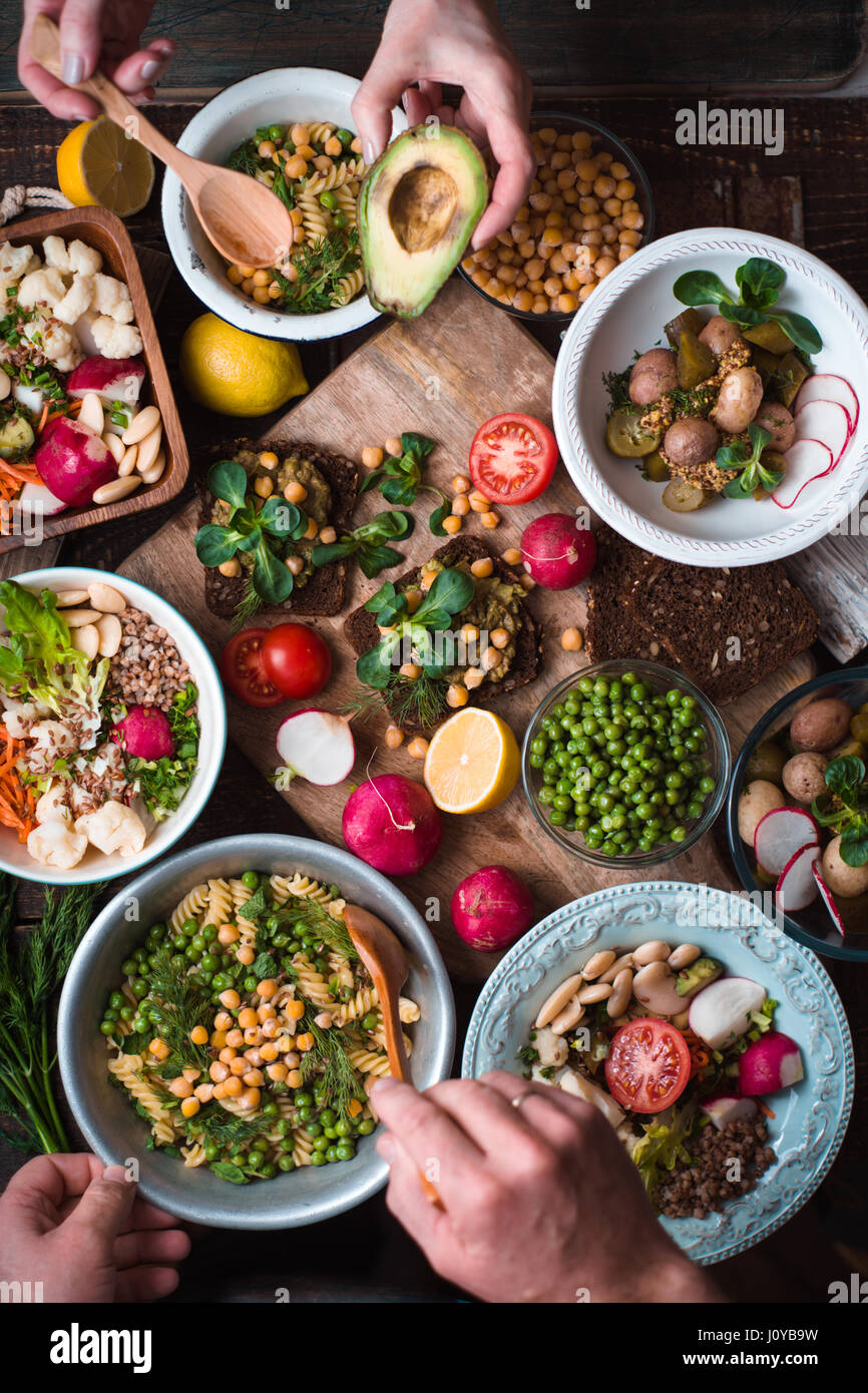 Feast with vegetable salads, fruits and sandwiches vertical Stock Photo ...