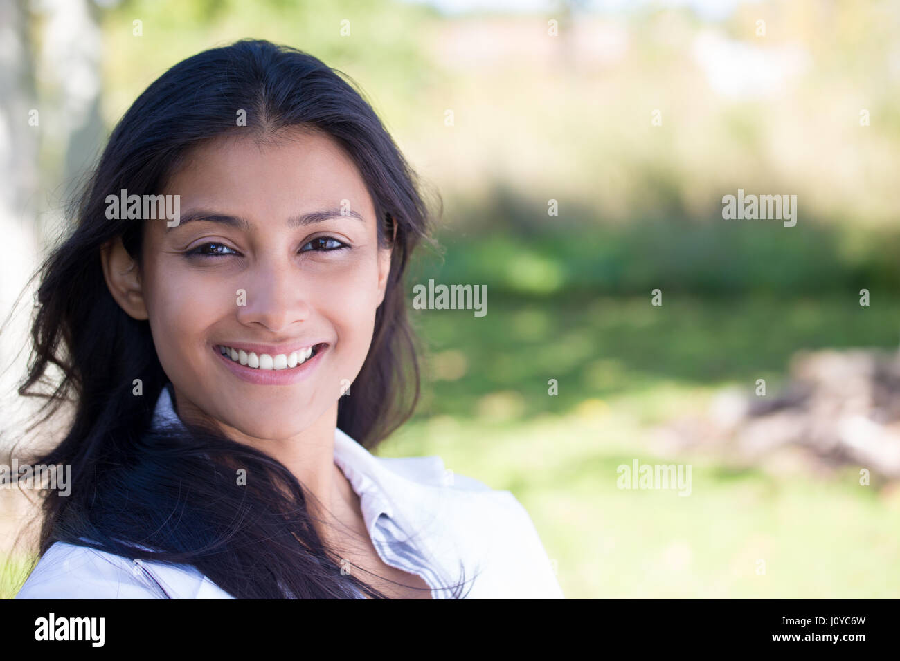 Closeup portrait of confident smiling happy pretty young woman in gray ... Closeup portrait of confident smiling happy pretty young woman in gray ...