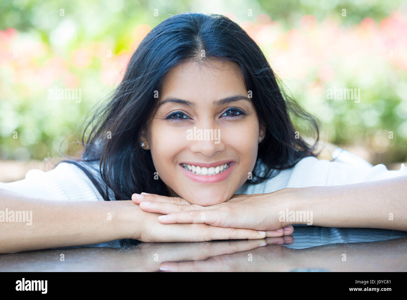 Closeup portrait confident smiling pretty young woman resting face on ...
