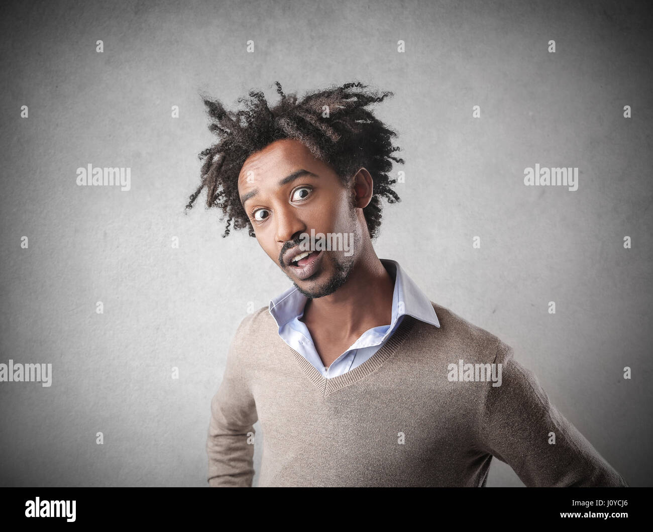Young black man looking into camera Stock Photo - Alamy