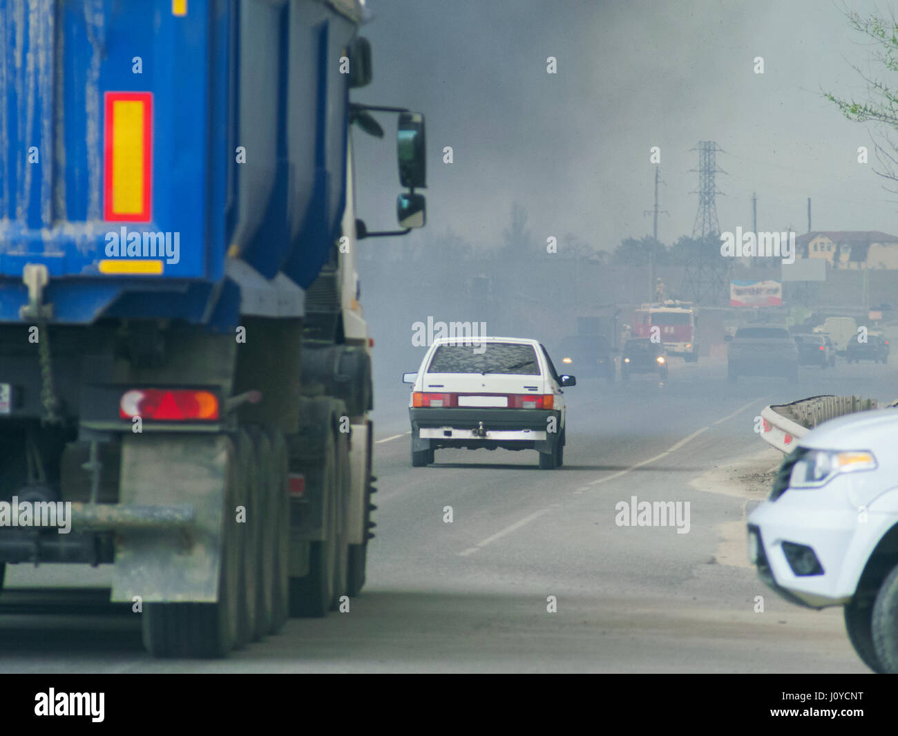 The cars in the smoke on the road Stock Photo - Alamy