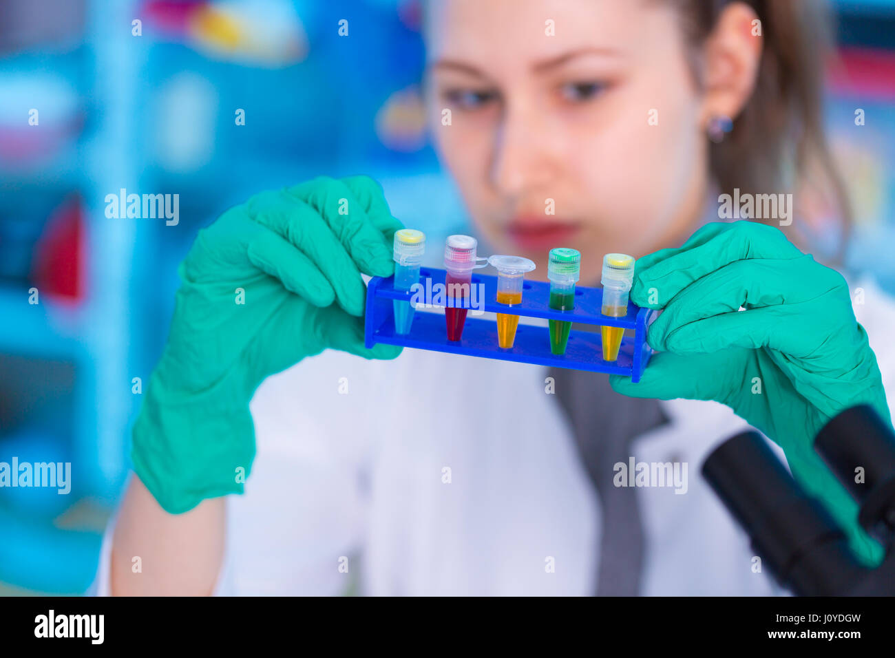 Woman technician with multipipette in genetic laboratory PCR research ...