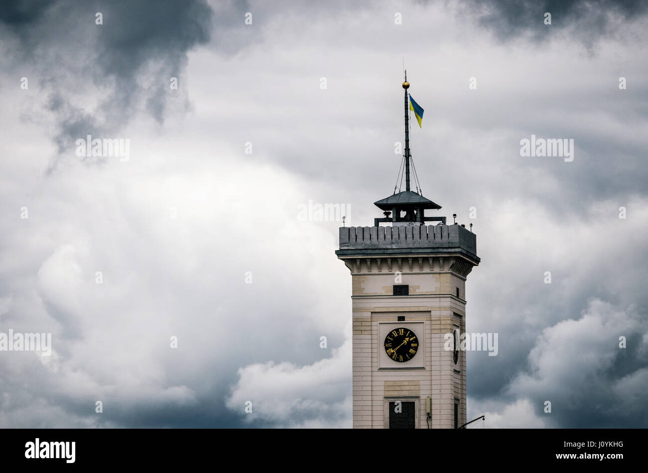City hall clock tower of Lviv with Ukrainian flag at the top against ...