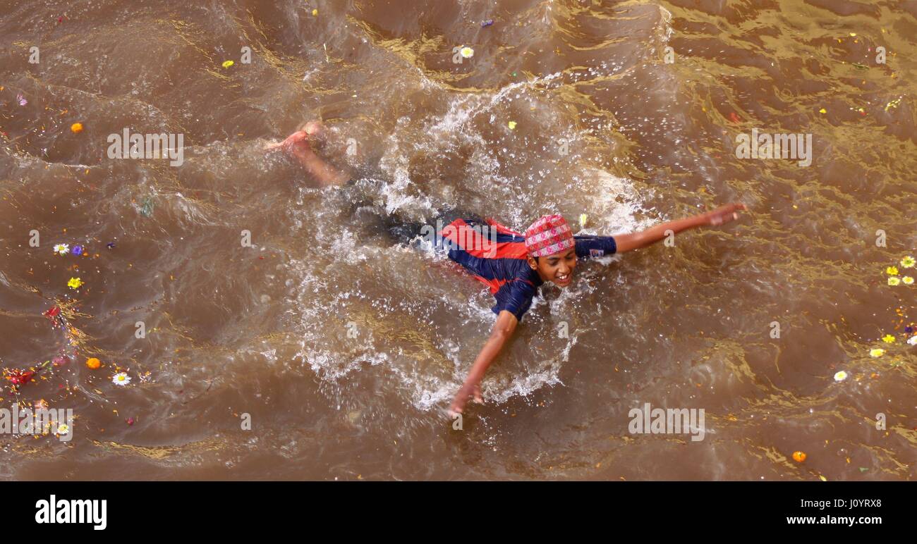 People carry chariots inside the pond in celebration of Tokha Bisket ...