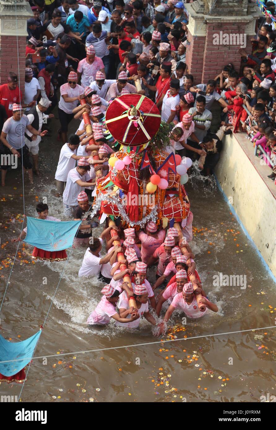 People carry chariots inside the pond in celebration of Tokha Bisket ...