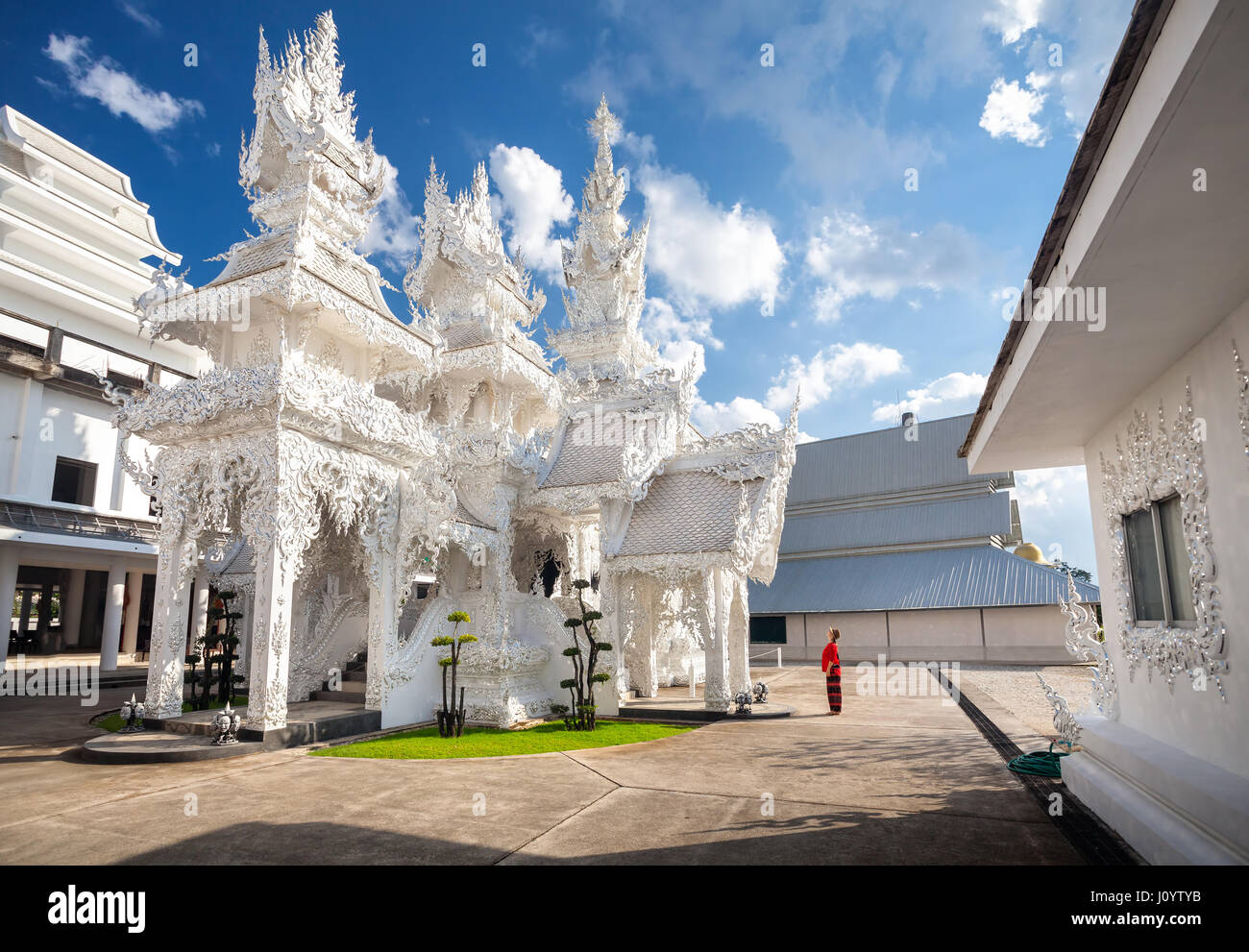 Woman in red costume in Wat Rong Khun The White Temple in Chiang Rai ...