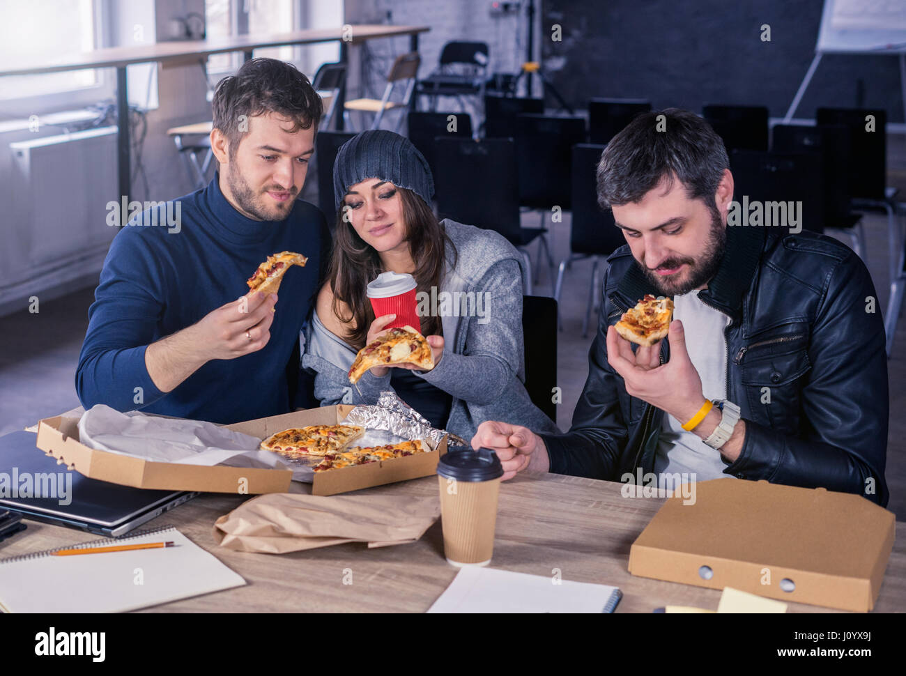 Business team eating pizza and drinking in office Stock Photo - Alamy