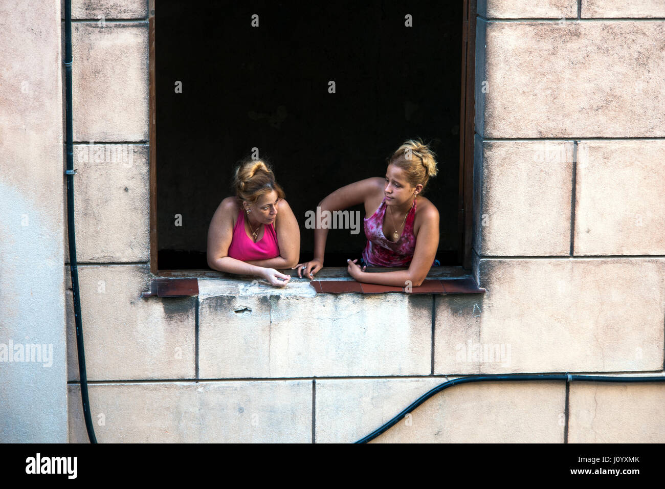 Two woman looking out of a window in Havana, Cuba Stock Photo - Alamy