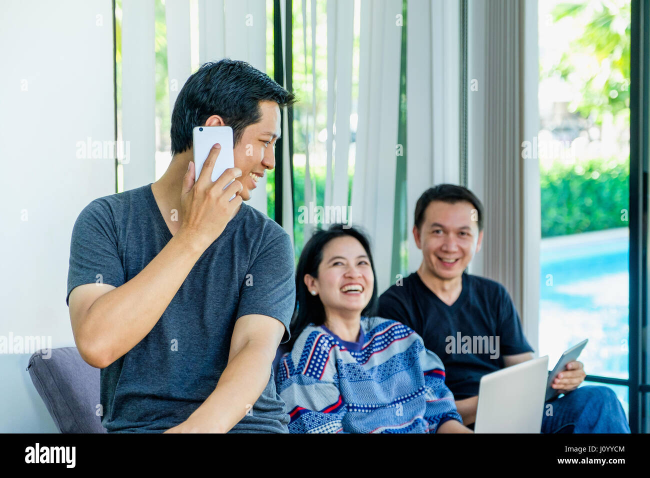 Group of friends having fun and using digital device (mobile,laptop ...