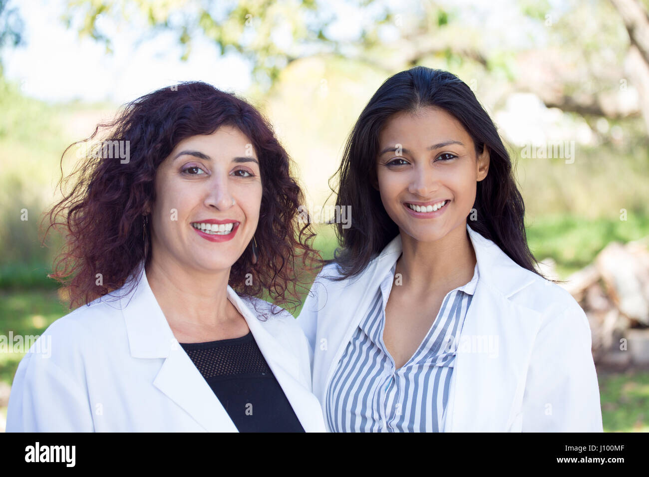 Closeup portrait of friendly, smiling confident female doctors ...