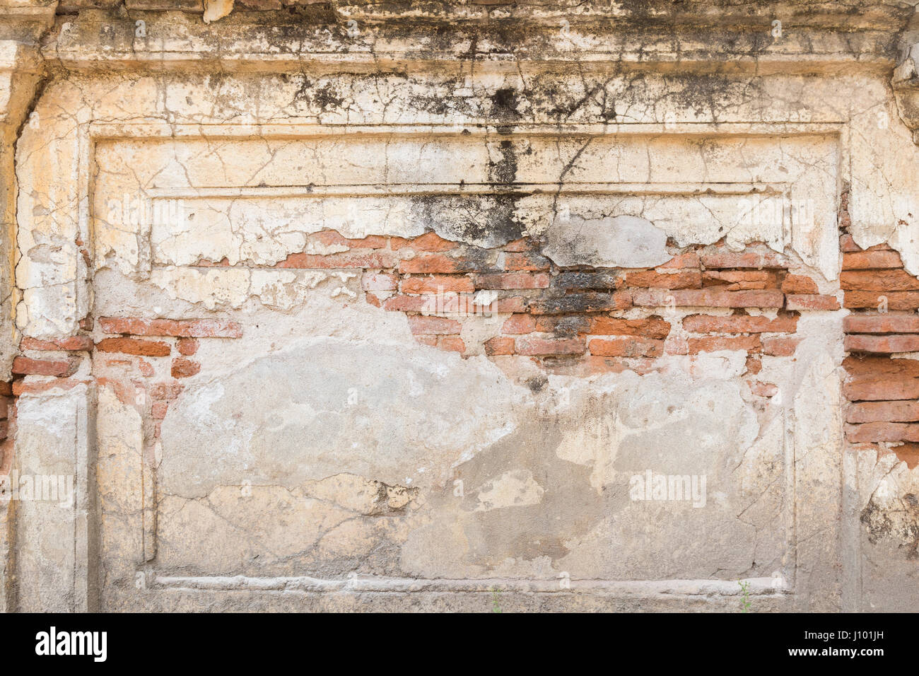 Broken, old and dirty plastered wall revealing old brick wall Stock ...