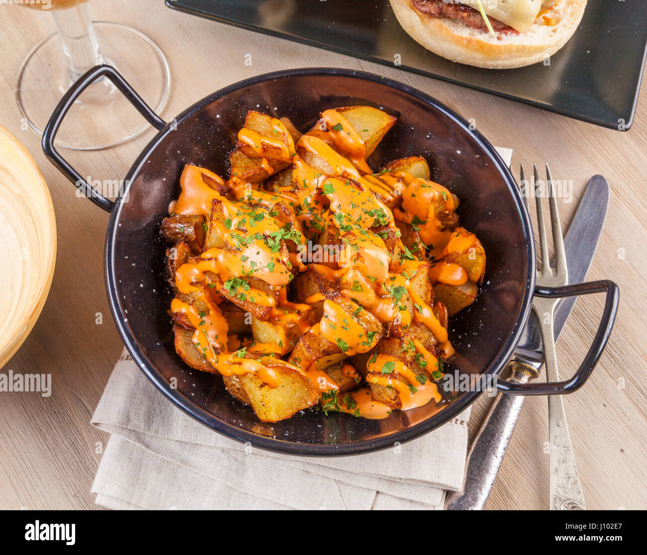 Patatas bravas, spicy potatoes, a typical Spanish dish with fried ...