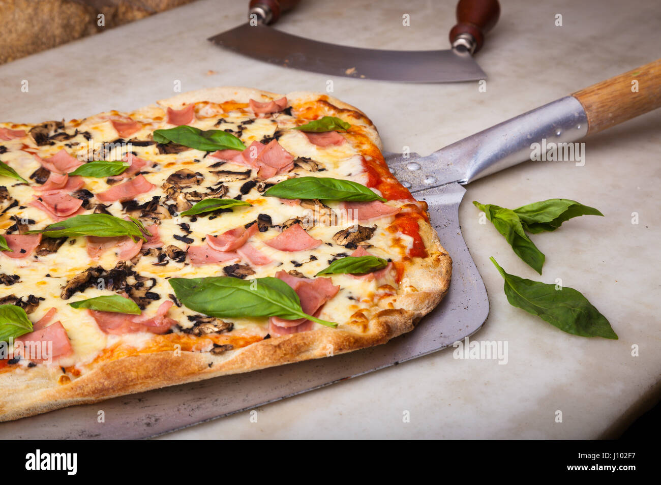 Hot pizza on a paddle, straight from the oven Stock Photo - Alamy