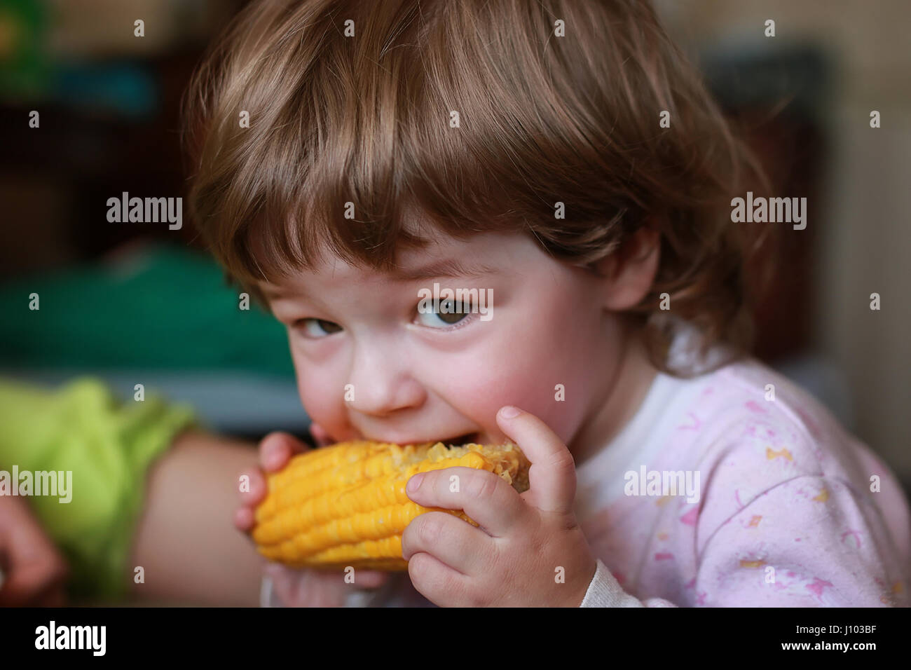 Child eating cob roasted corn food hi-res stock photography and images ...