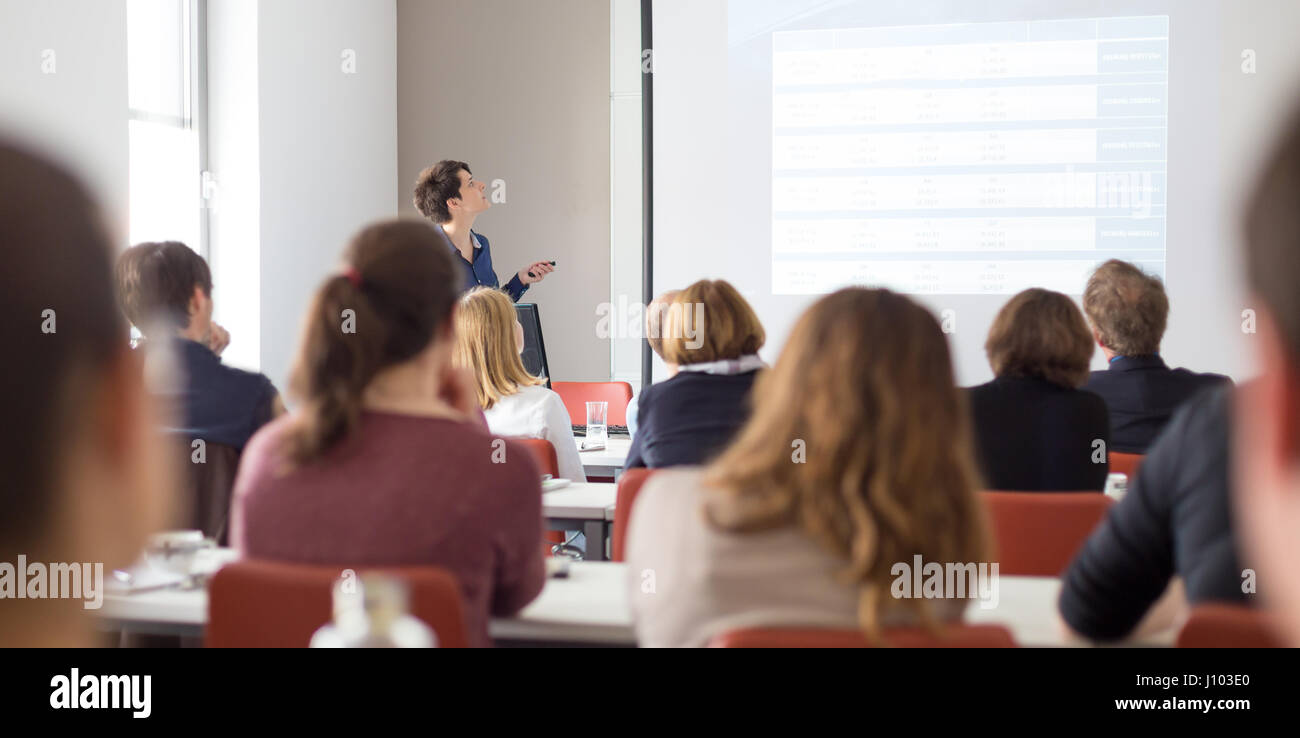 Woman giving presentation in lecture hall at university Stock Photo - Alamy