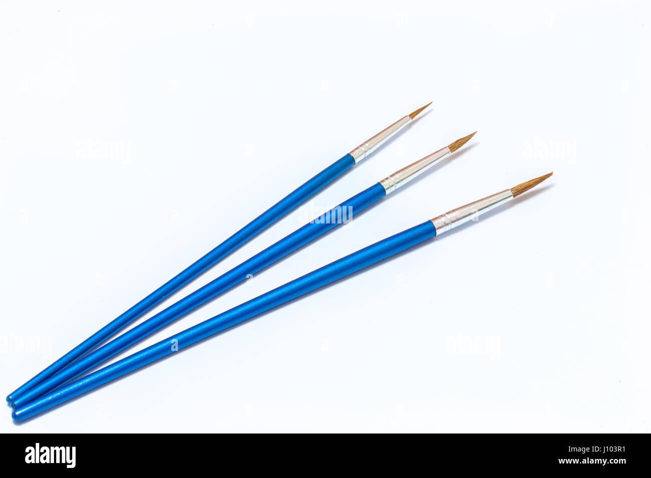 Three blue paint brushes on a white background. Isolated Stock Photo ...