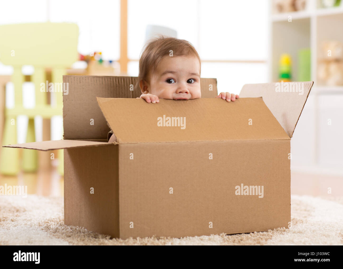 Boy hiding inside cardboard box hi-res stock photography and images - Alamy