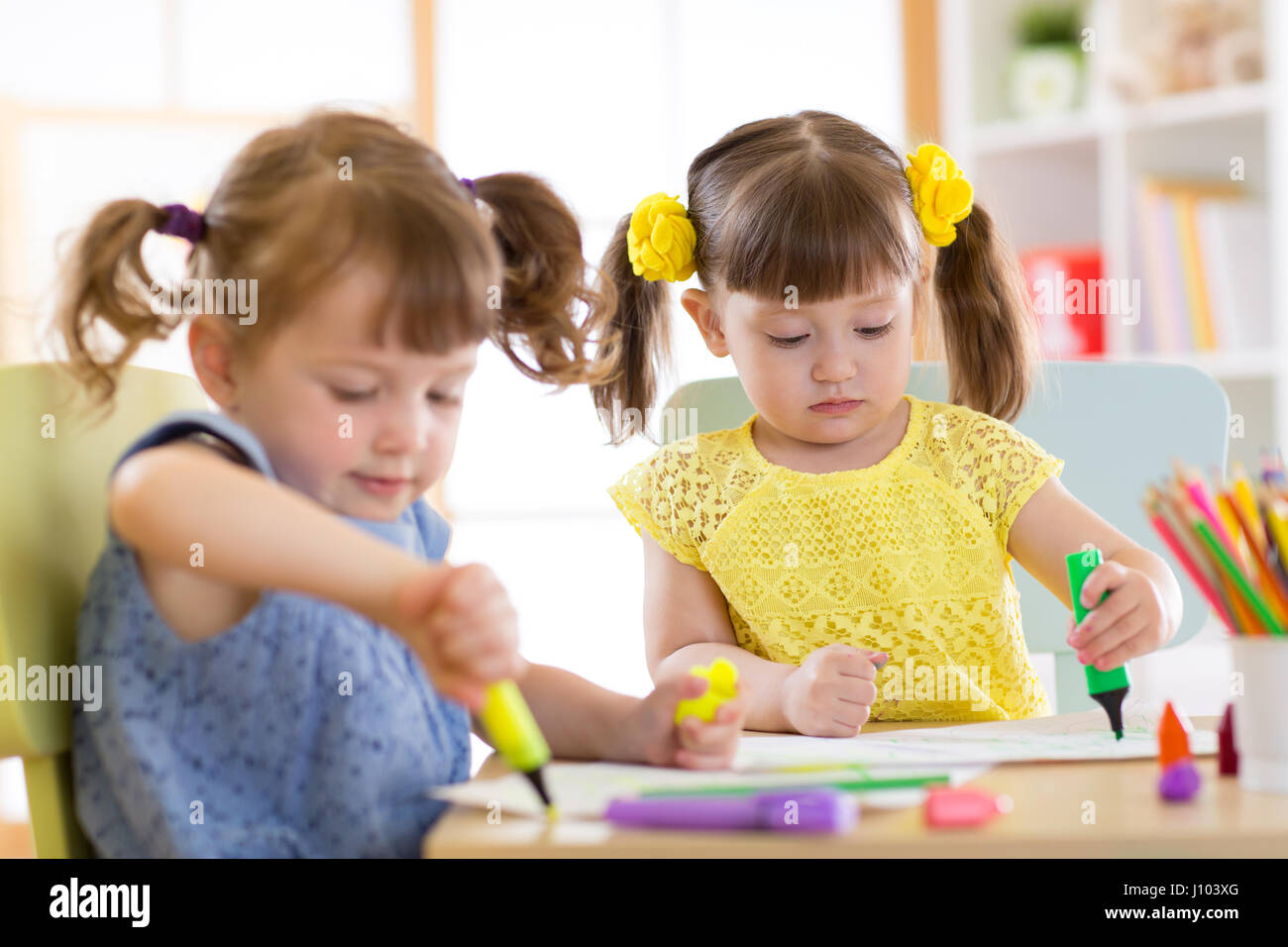 Smiling adorable kids drawing together at hobby group indoors Stock ...
