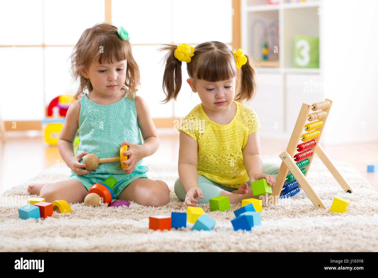 Children playing together with building blocks. Educational toys for ...