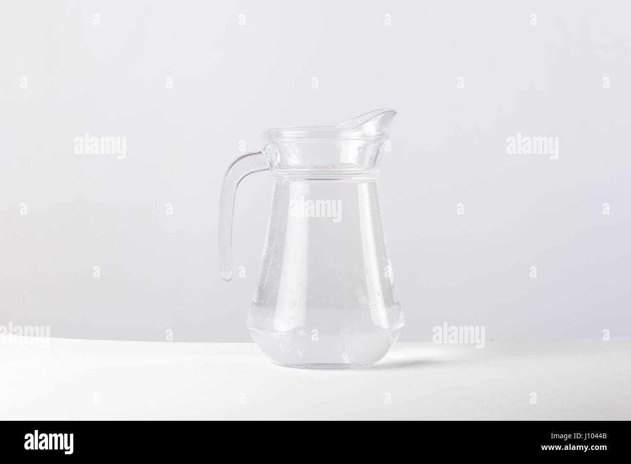 glass jug with water isolated on white background Stock Photo - Alamy