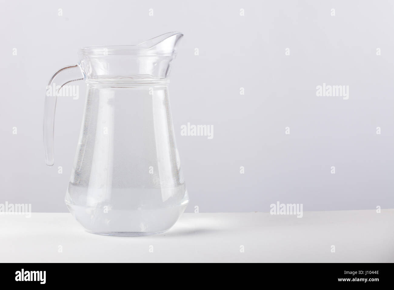 glass jug with water isolated on white background Stock Photo - Alamy