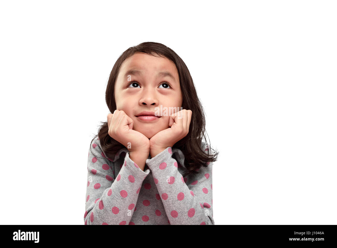Smiling asian little girl with rolling eyes is happy and excited ...