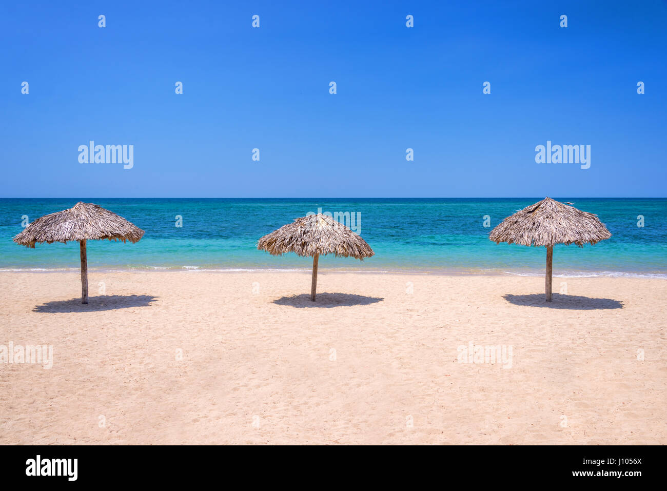 Caribbean tropical beach straw umbrella hi-res stock photography and ...