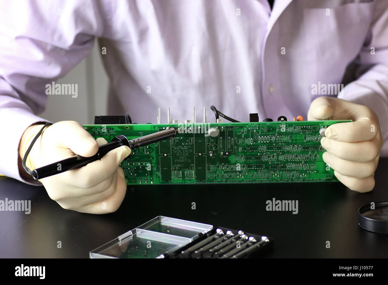 Male worker soldering cable hi-res stock photography and images - Alamy