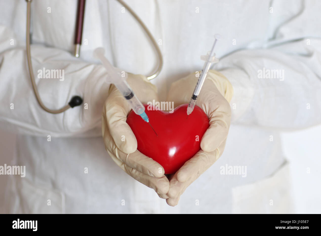 syringe in heart doctor hand Stock Photo - Alamy