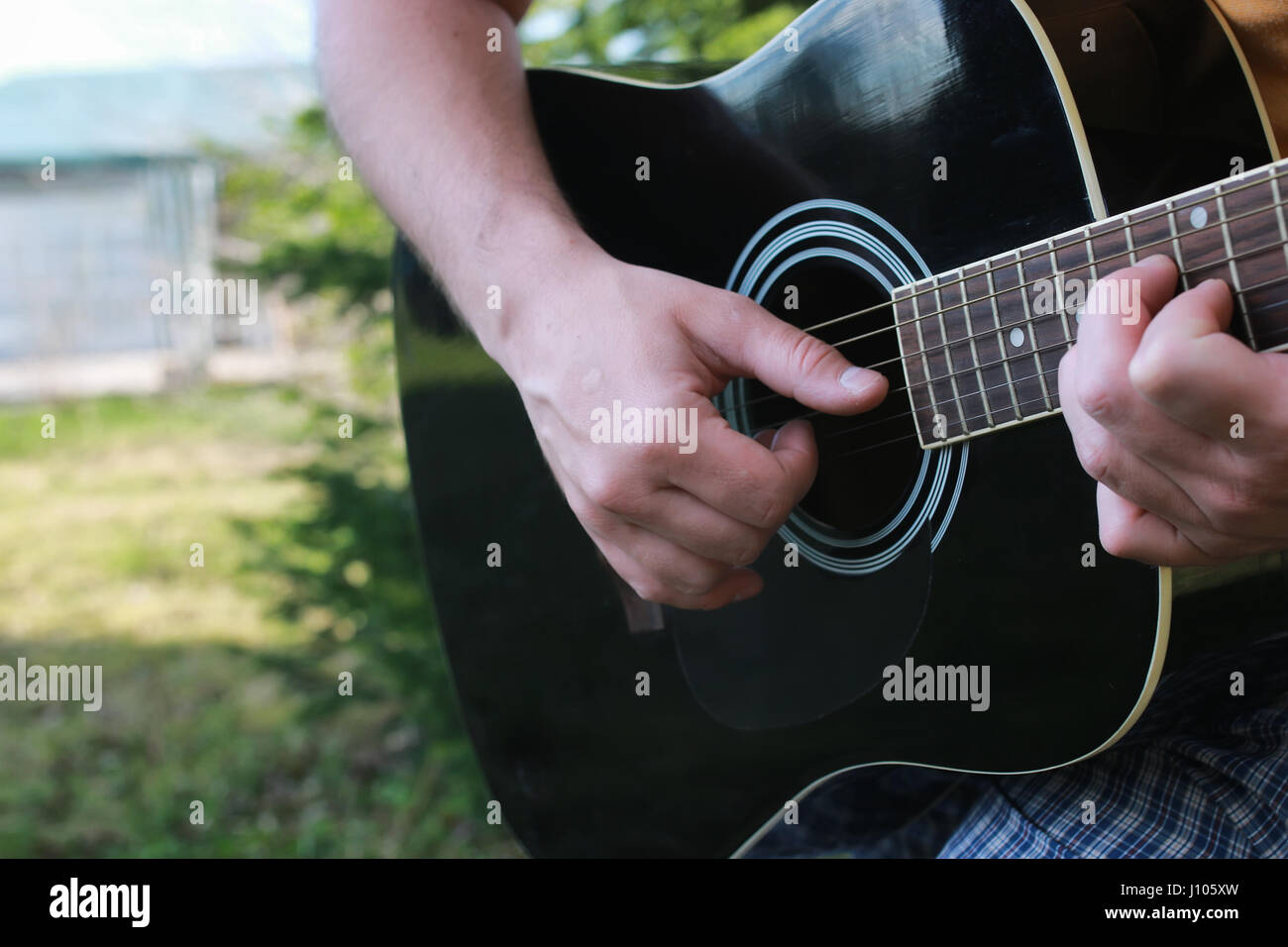 guitar string man hand outdoor Stock Photo - Alamy