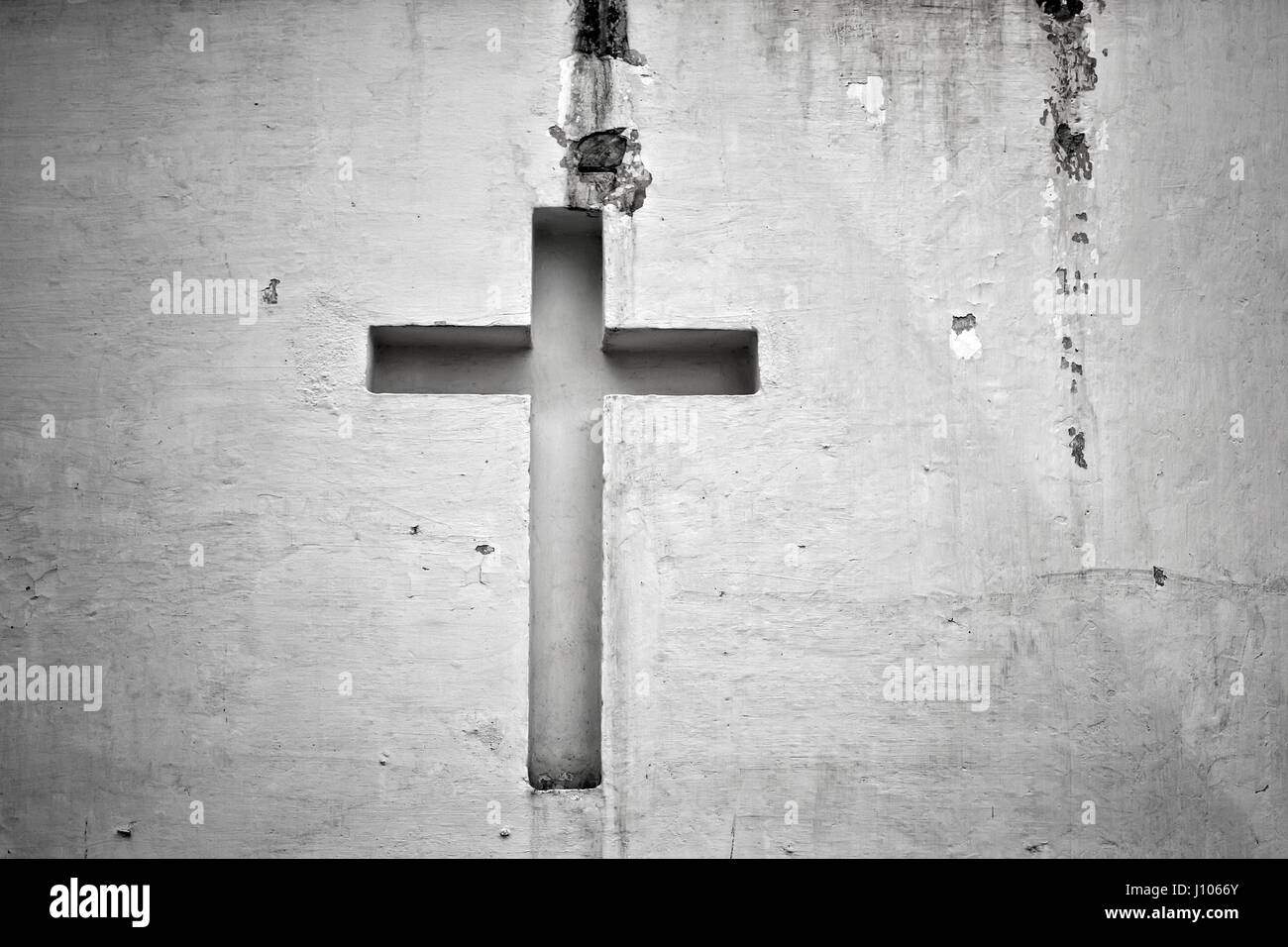 Cross figure religion wall Stock Photo - Alamy