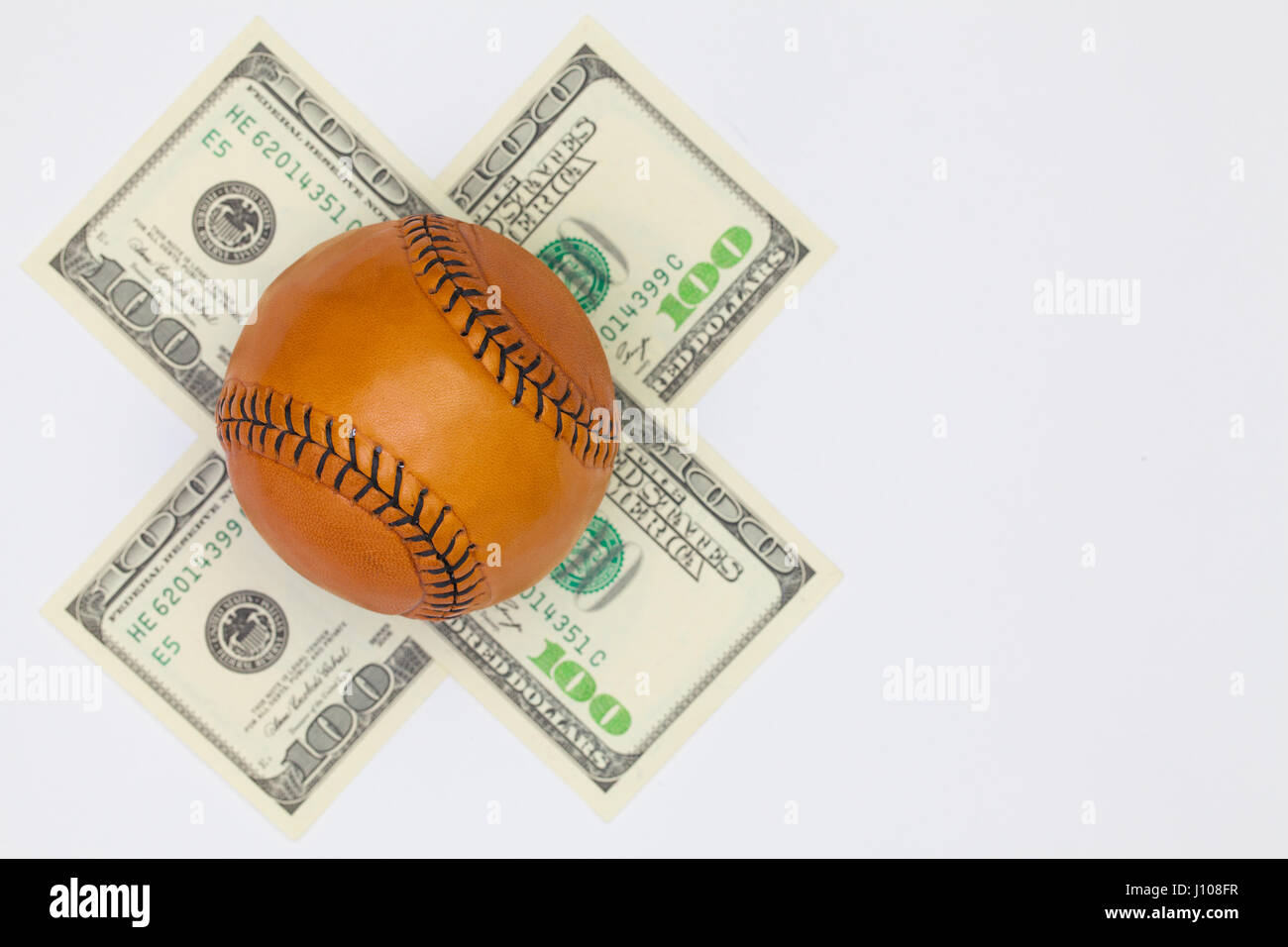 Leather baseball ball and us dollar banknotes on the white table. Flat ...