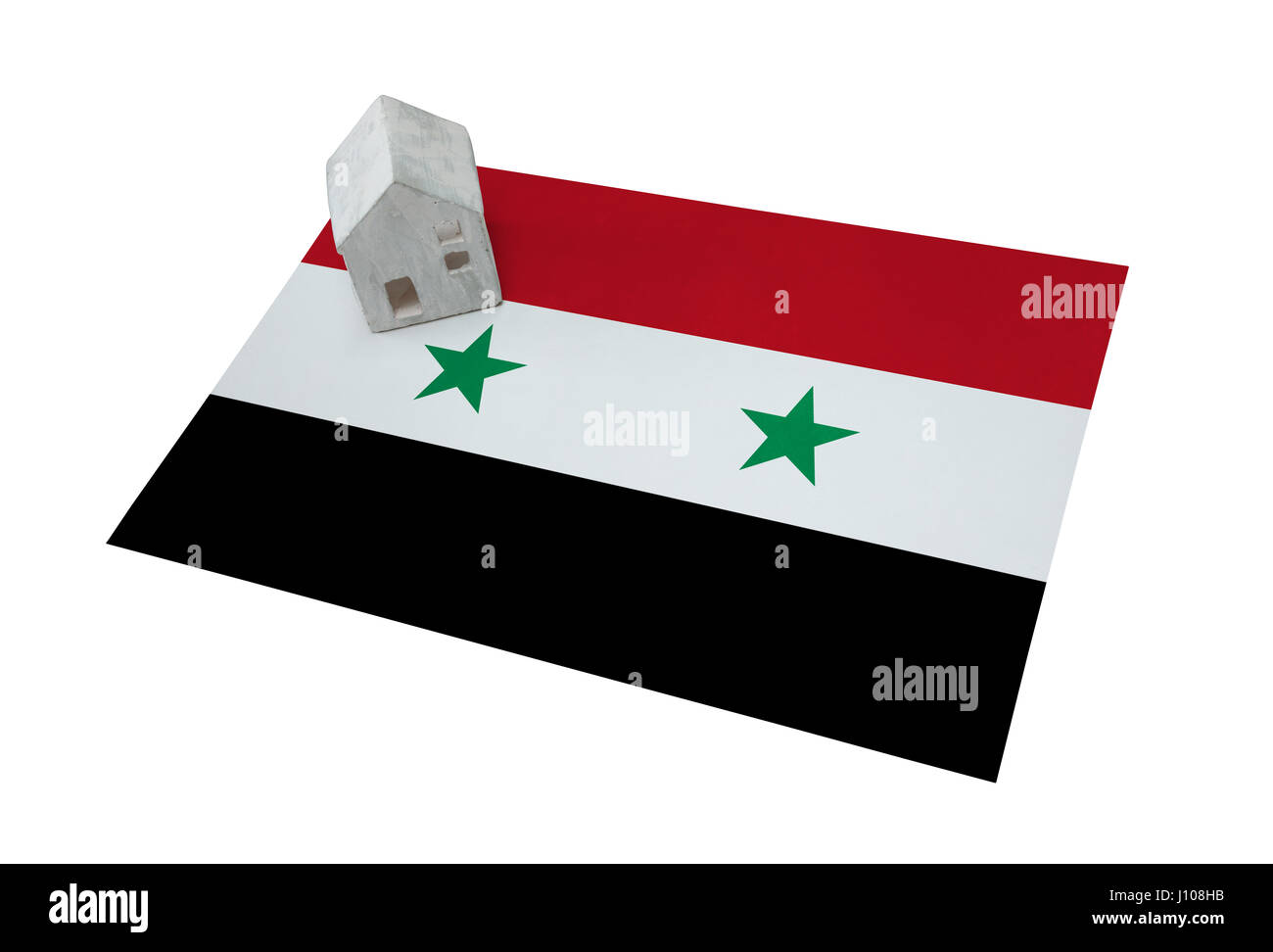 Small house on a flag - Living or migrating to Syria Stock Photo - Alamy