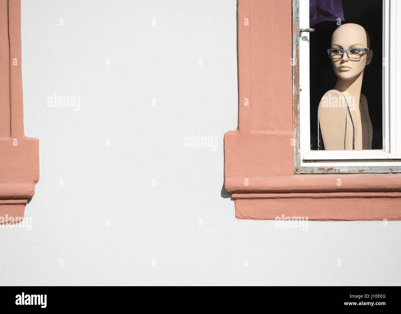 A shop window dummy has been placed by the window of an optician in ...