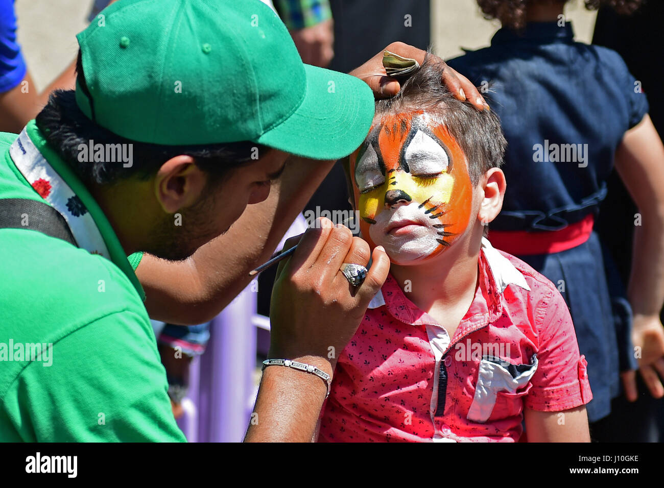 Cairo, Egypt. 17th Apr, 2017. An Egyptian boy has color oil painted on ...