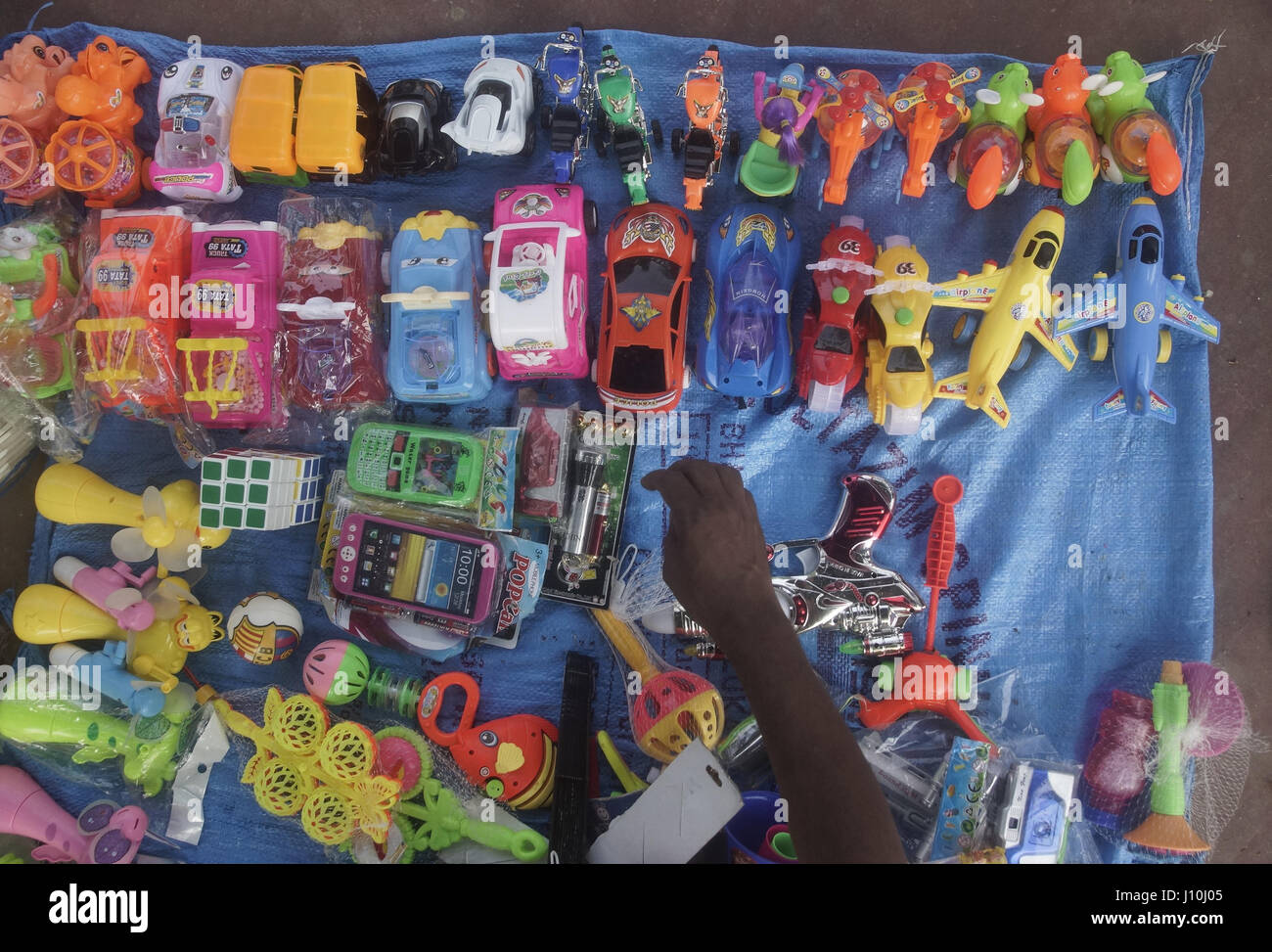 Dhaka, Bangladesh. 17th Apr, 2017. A street vendor set up his toy store at Dhaka. Credit: Md ...