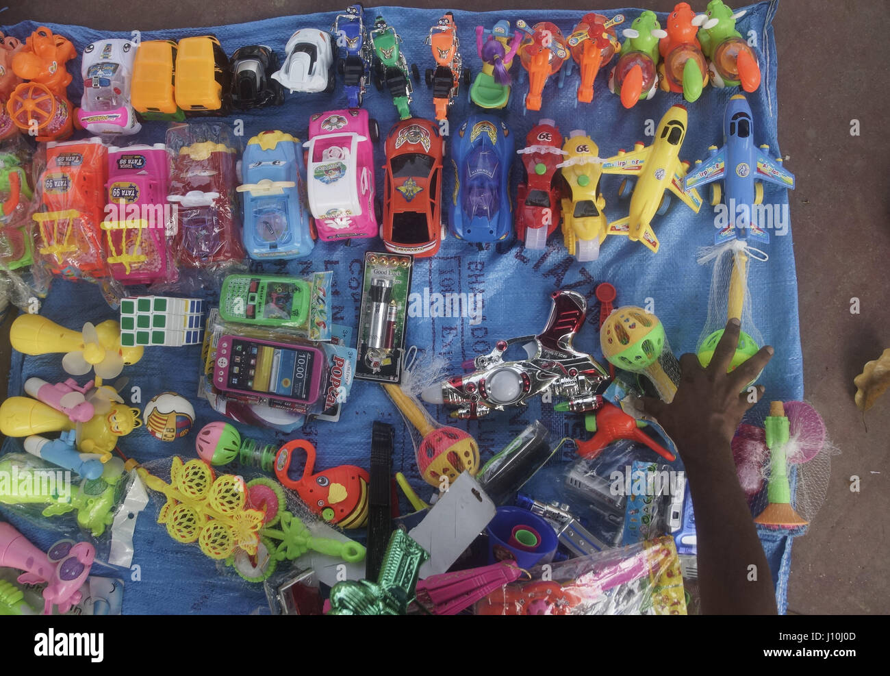 Dhaka, Bangladesh. 17th Apr, 2017. A street vendor set up his toy store ...
