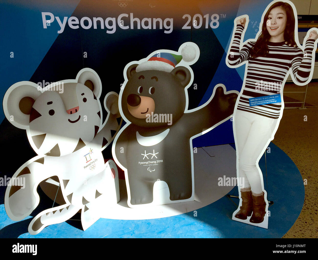 A cardboard poster shows the mascots for the Winter Olympics 2018 in ...