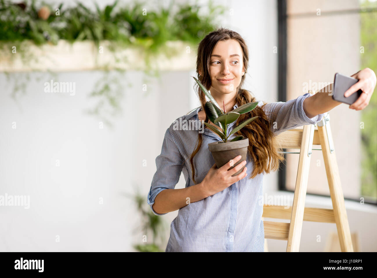Woman with phone at home Stock Photo - Alamy