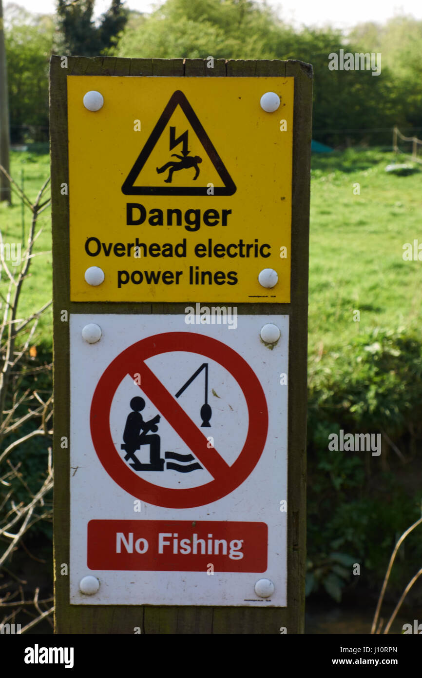 Danger overhead pylon sign on canal towpath. UK Stock Photo - Alamy