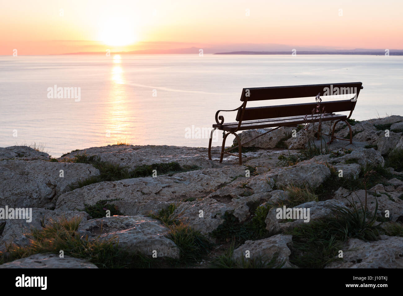 Sunset beach and bench Stock Photo - Alamy