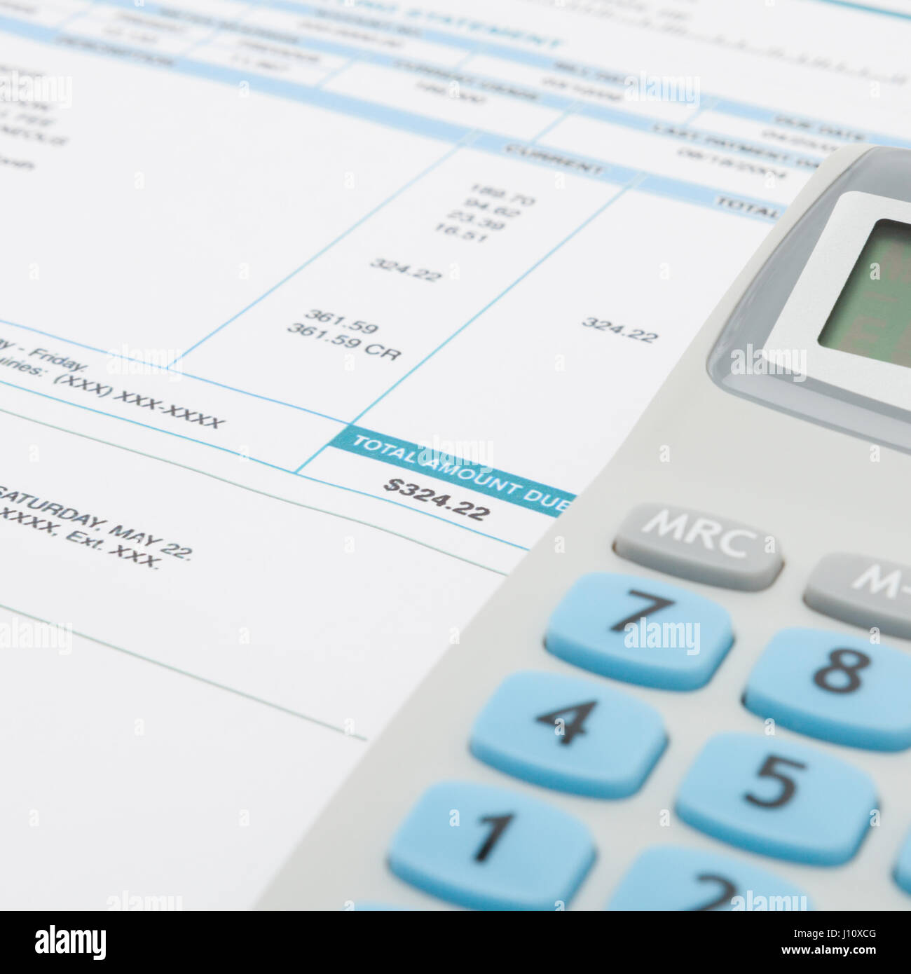 Utility bill and calculator - close up shot Stock Photo - Alamy