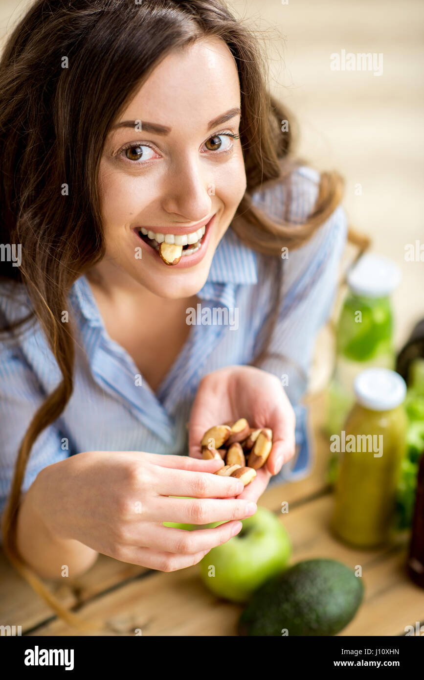 Woman eating nuts Stock Photo - Alamy