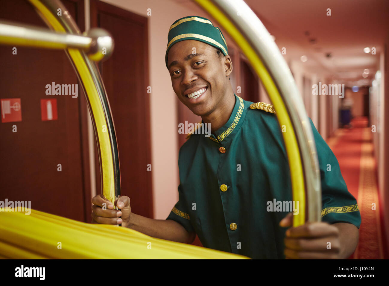 Happy porter doing his work in hotel Stock Photo - Alamy
