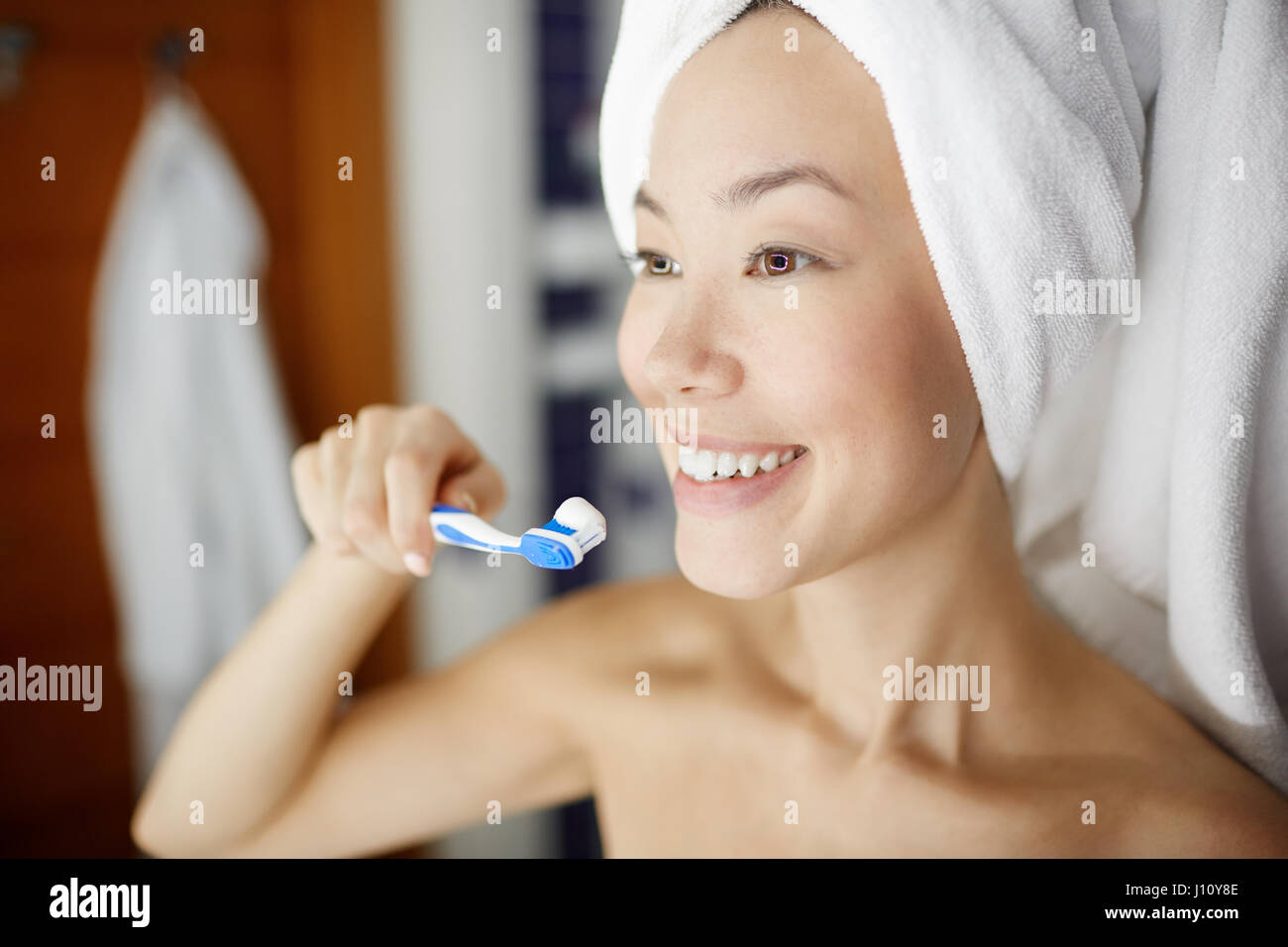 Fresh young woman cleaning her teeth Stock Photo - Alamy
