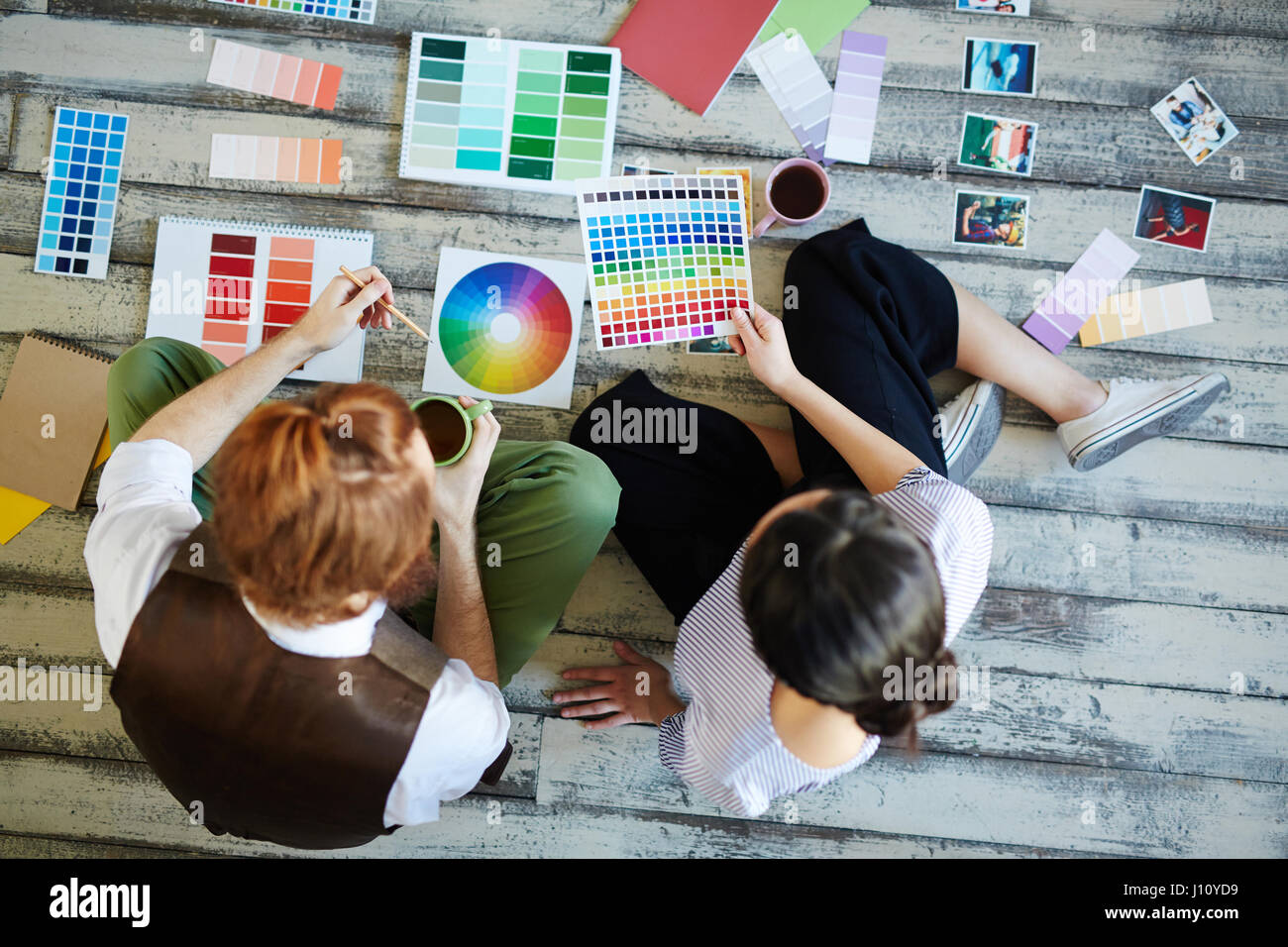 Two designers choosing colors from palette Stock Photo - Alamy
