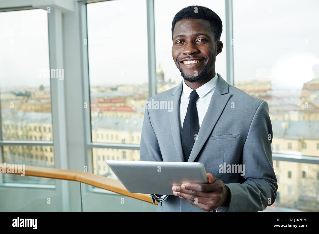 Successful banker with touchpad working online Stock Photo - Alamy