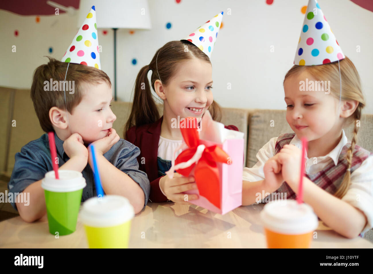 Boy and girl congratulating their friend in kindergarten Stock Photo ...